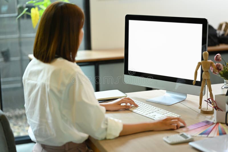 Back View of Young Female Employee Working with Computer at Creative ...