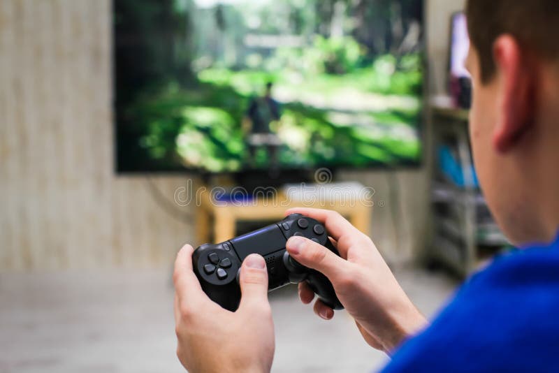 Back View of Young Gamer Playing Video Game Using His Controller Stock ...