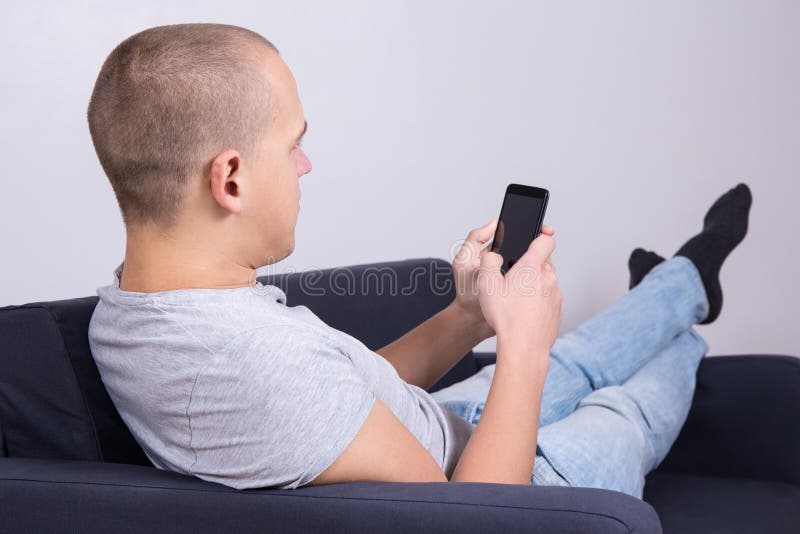 Back View of Young Handsome Man Using Smart Phone Stock Photo - Image ...
