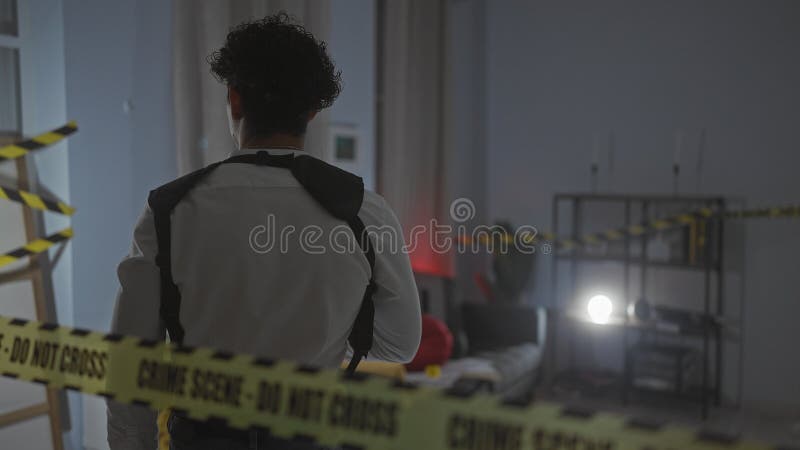 Back View of a Young Hispanic Man Observing a Dimly Lit Indoor Crime ...