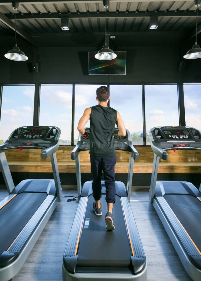 Back View of Young Man Athlete with Running on Treadmill in Gym. Stock ...