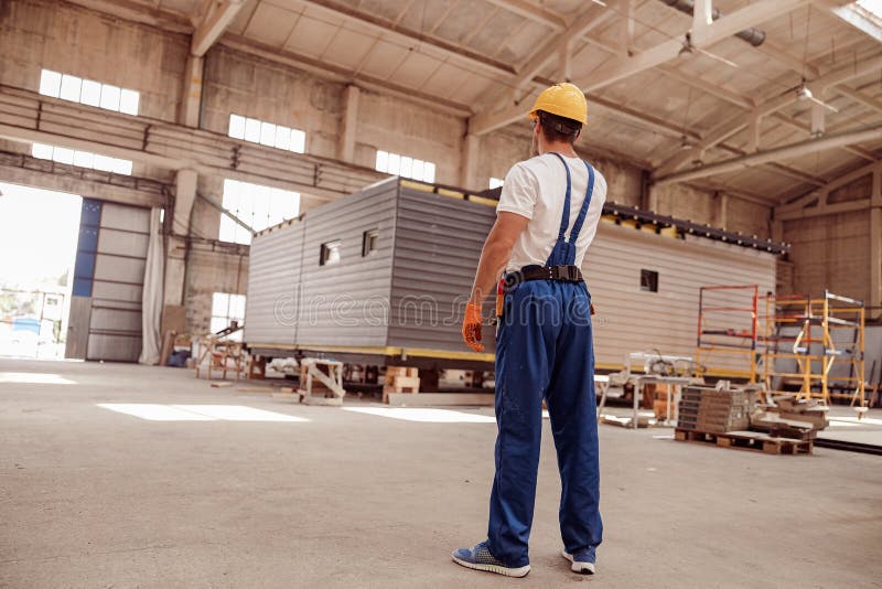 Male Builder Standing Inside Building with Construction Cabin Stock ...