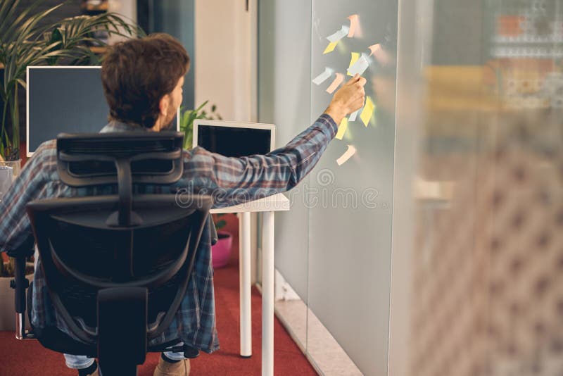 Male Worker Using Sticky Notes in Office Stock Image - Image of gadget ...