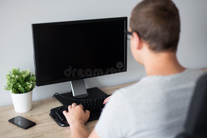 Back View of Young Man Using Computer - Blank Screen with Copy Space ...