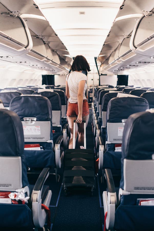 Back View of Young Woman Walking the Aisle on Plane Stock Photo - Image ...