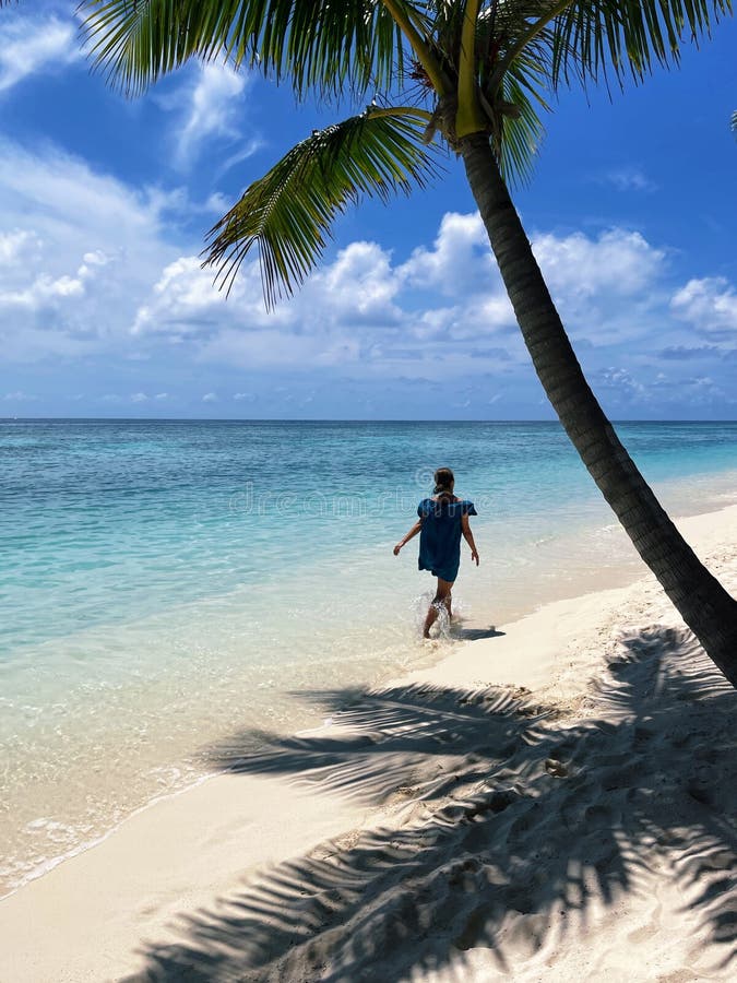 Back View of Young Woman Walking on a Tropical Beach Stock Photo ...