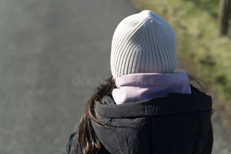 Back View of a Young Woman in Winter Jacket and Hat on the Road Stock ...