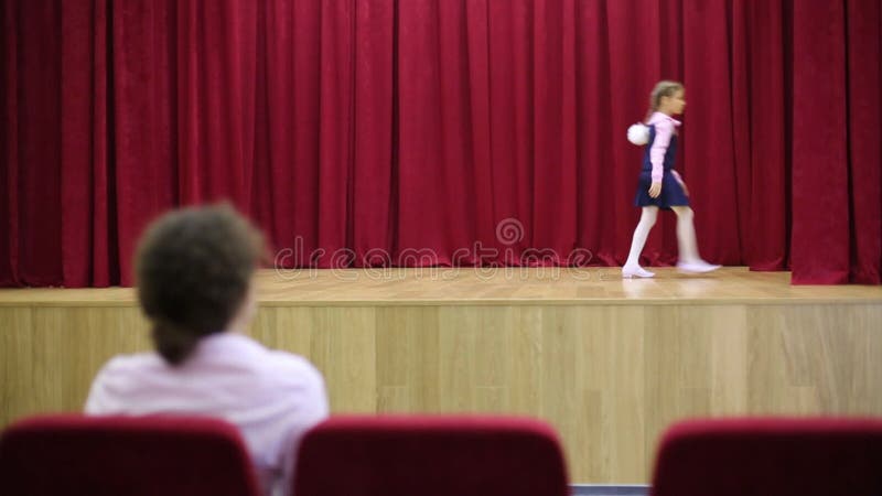 Back of Woman Looking on Dancing Girl on Stage. Stock Footage - Video ...