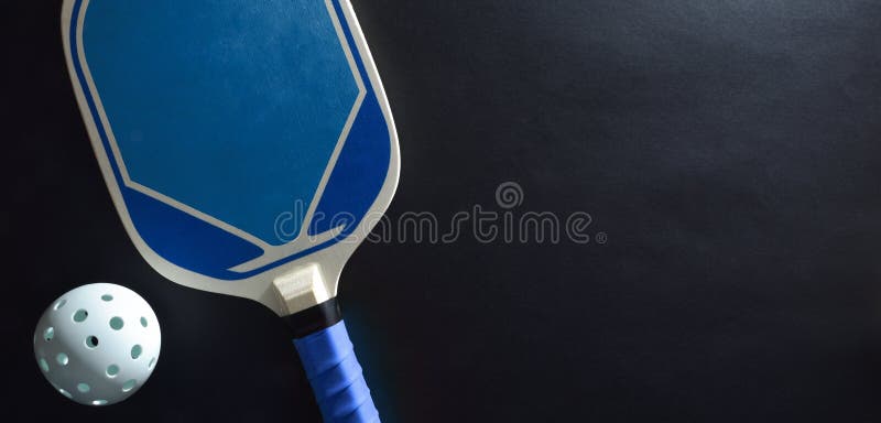 Background of Blue Pickleball Paddle and White Ball on Black Table ...