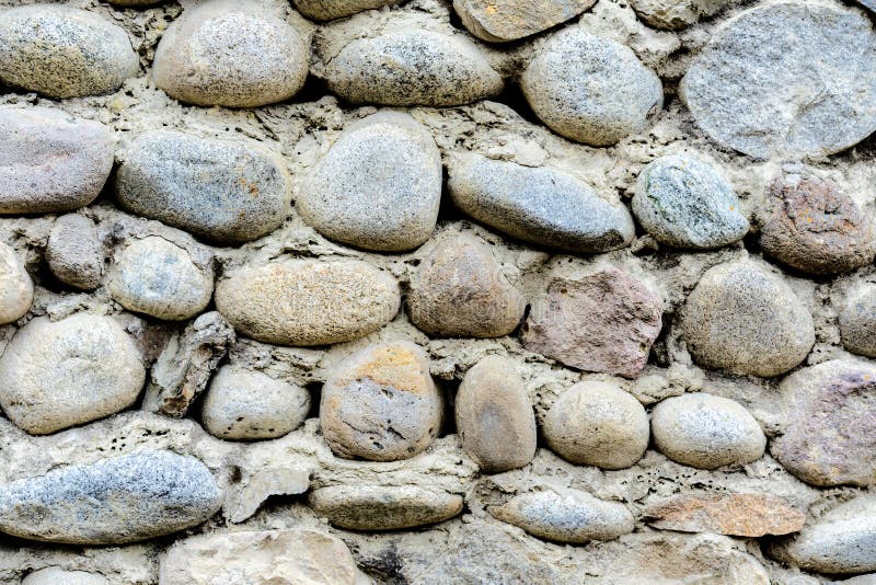 Background from a Brown Natural Round Stone Wall Stock Image - Image of ...