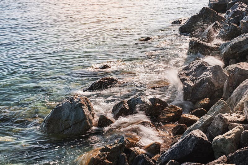Background of Clear Waters Against a Rocky Beach Stock Photo - Image of ...