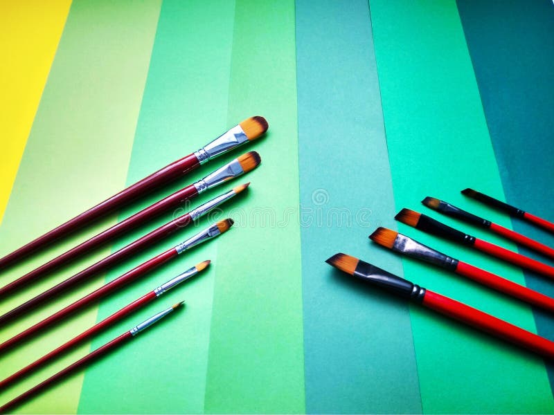 Paint Brushes on a Background of Colored Paper Stock Photo - Image of ...