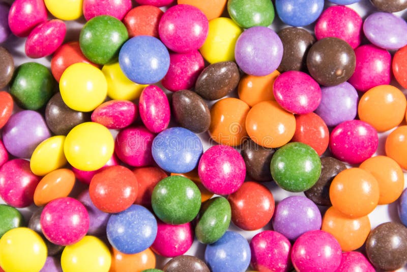 Background of Colorful Button Shaped Candies Filled with Chocolate ...