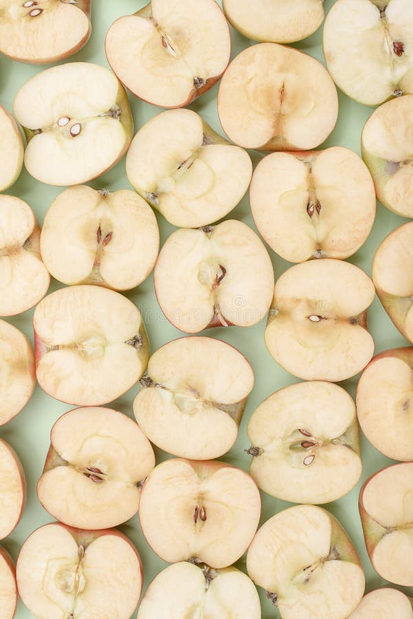 Background of Cut in Half Apples on Green Background Stock Photo ...