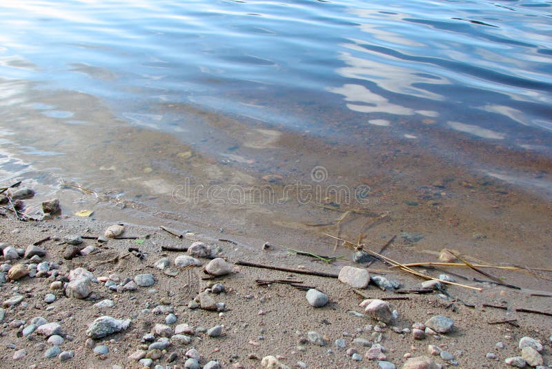 Background of the Edge of Water at the Sandy Beach with Pebbles and ...