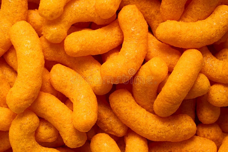 Background of Extruded Cheese Puffs. Top View Stock Photo - Image of ...