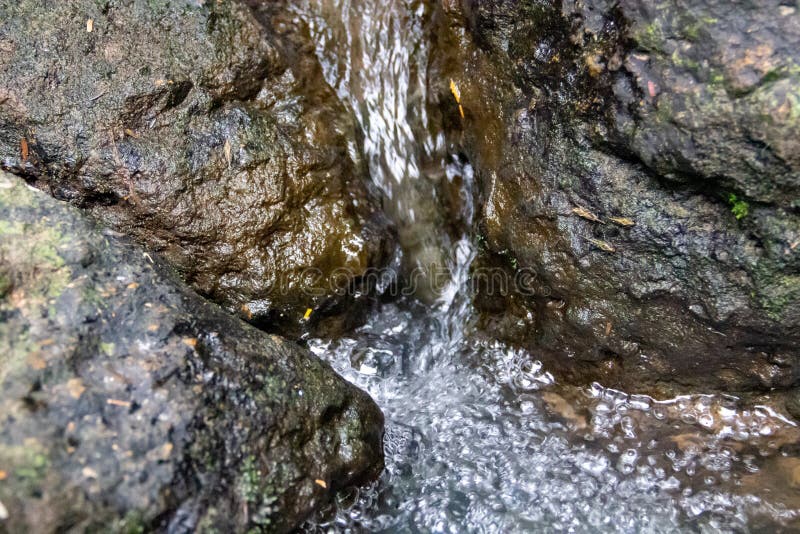 Background Flowing Water Falling between the Rocks in the River Stock ...