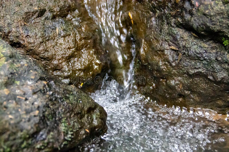 Background Flowing Water Falling between the Rocks in the River Stock ...