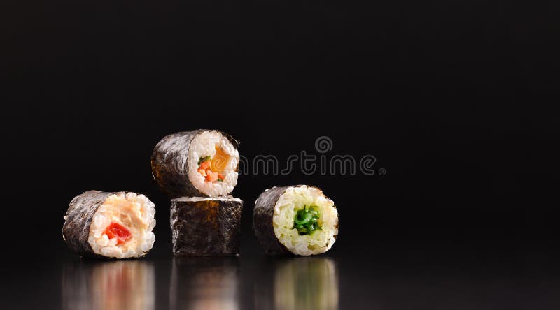 Background with Four Assorted Vegetable Maki Sushi on Dark Wooden Stock ...