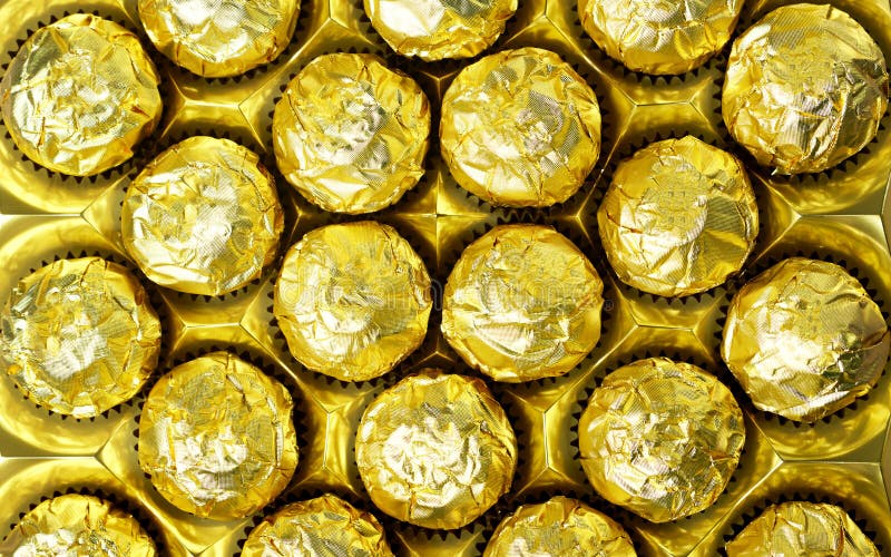 Background of Golden Premium Chocolate Sweets for Holidays Stock Photo ...