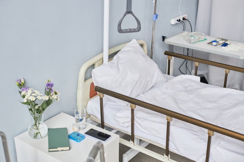 Background Image of Bed in Hospital Room Interior with Flowers on ...