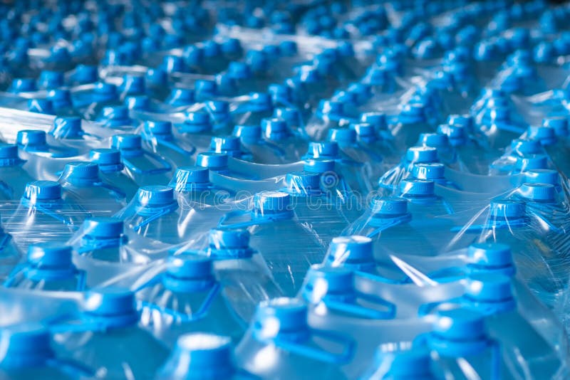 Background Image of Blue Plastic Bottles with Blue Caps in Packaging ...