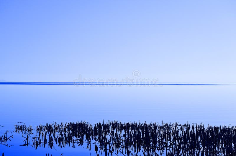 The Background Image Features a Perfectly Smooth Surface of a Lake ...