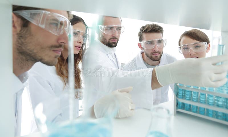Background Image is a Group of Microbiologists Studying the Liquid in ...