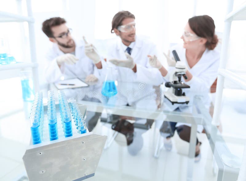 Background Image of Scientists Studying Blue Liquid in a Flask Stock ...