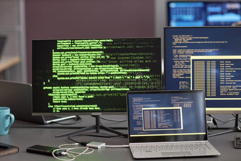Background Image of Multiple Computer Screens with Green Code Lines at ...