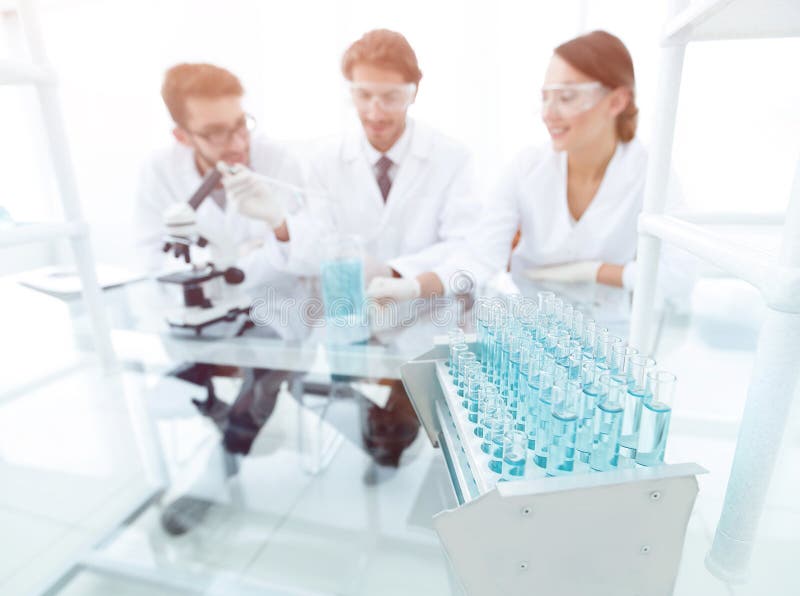 Background Image of Scientists Studying Blue Liquid in a Flask Stock ...