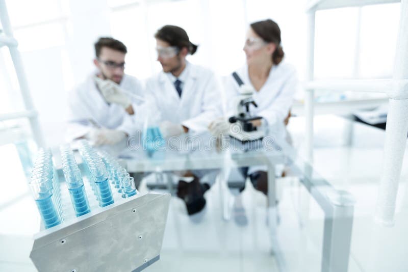 Background Image of Scientists Studying Blue Liquid in a Flask Stock ...