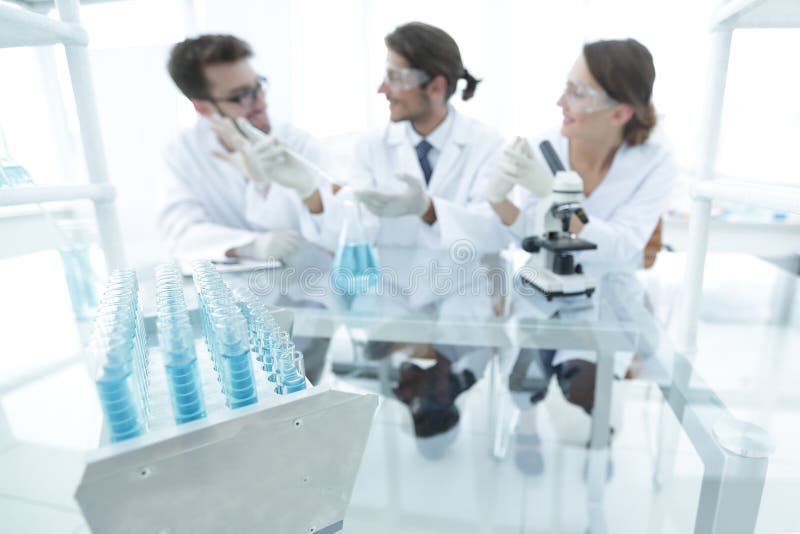 Background Image of Scientists Studying Blue Liquid in a Flask Stock ...