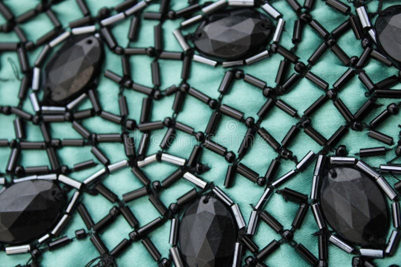 Background Image of a Shiny Fabric. on a Turquoise Background are Black ...