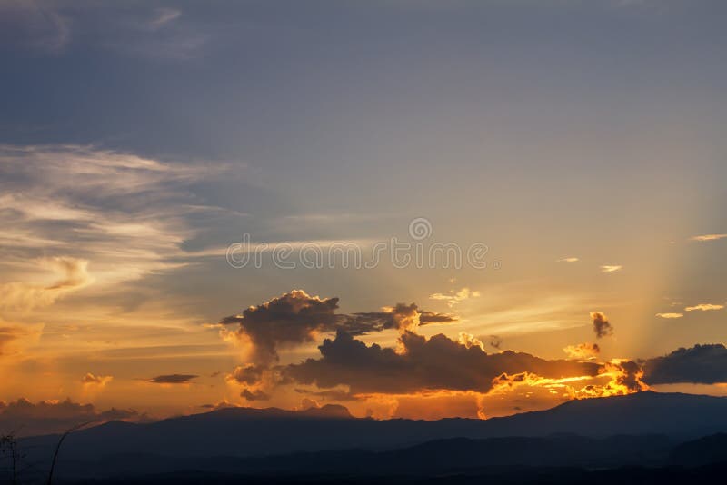 The Background Image of the Sun is Falling Behind the Mountain. Stock ...