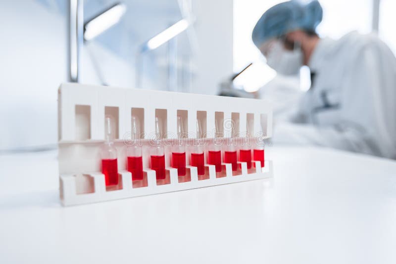 Background Image of a Test Tube with Test Results on a Table in the ...