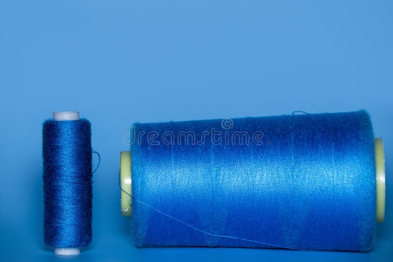 Background with a Large and Small Blue Spool of Thread. they Lie Next ...