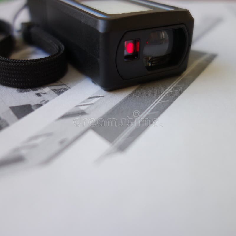 Laser Ruler on the Table with Drawings and Layout of the Apartment ...