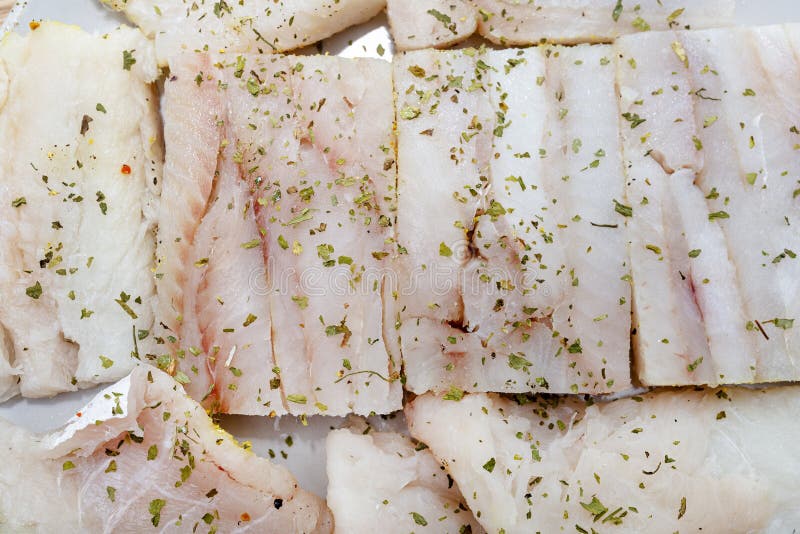 Background Made of Cod Fish Fillet Cut into Squares and Sprinkled with ...