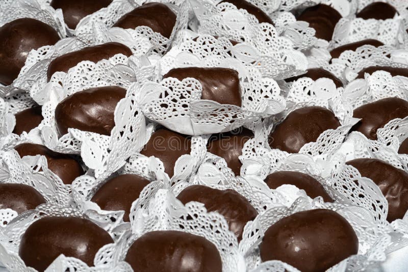 Background from Many Chocolates on White Pieces of Paper Stock Image ...