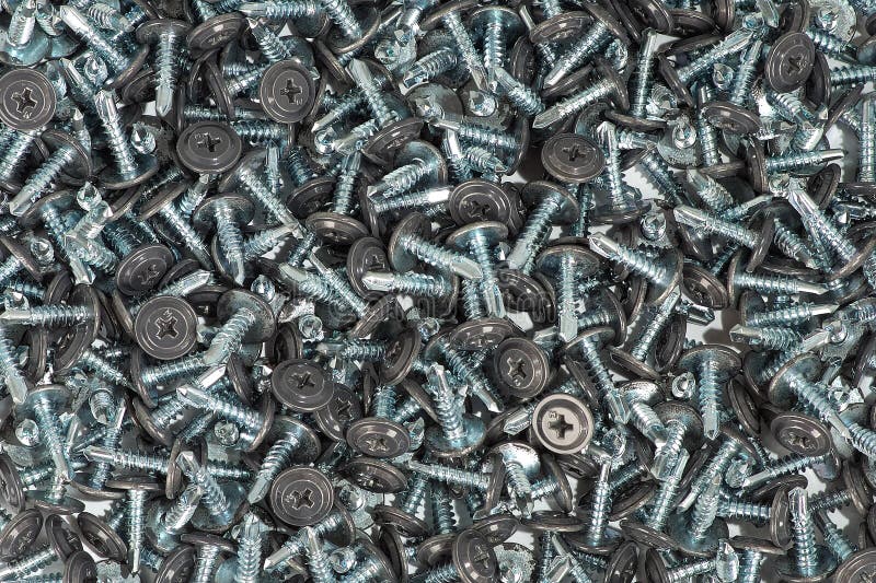 Background of a Many Gray Screws Scattered on a Table Stock Photo ...