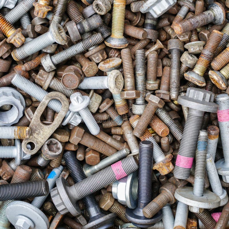 Background with Many New and Used Bolts and Nuts of Various Sizes and ...