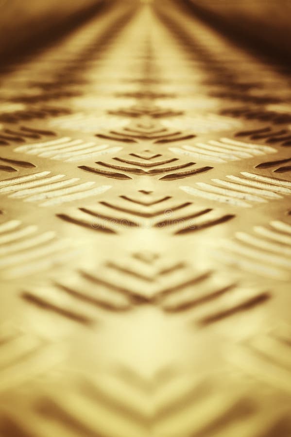 Background of Metal with a Repeating Pattern of Bronze Color. Close-up ...