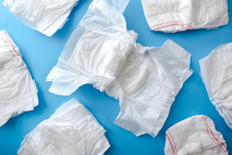 Background with New and Clean Diapers Isolated on Blue Table Stock ...