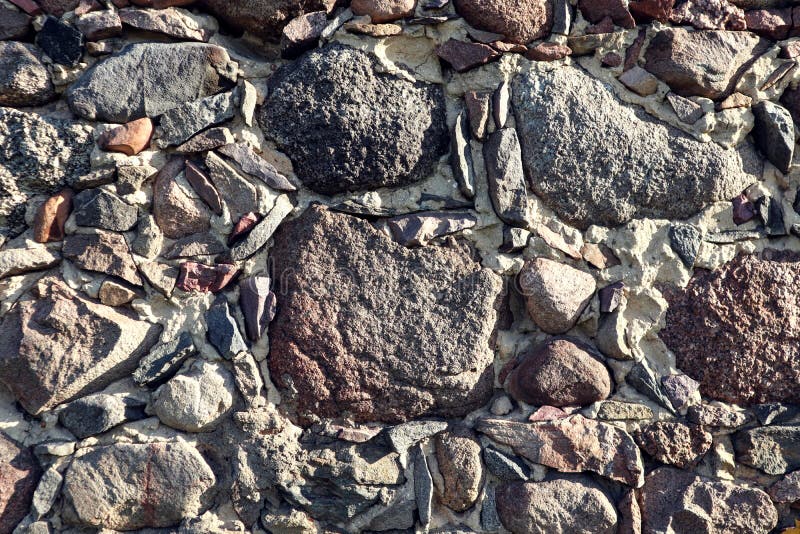 Background of an Old Stone Wall Made of Various Types of Stone with ...