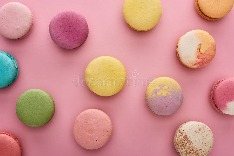 Background Pattern with Multicolored Delicious French Macaroons on Pink ...