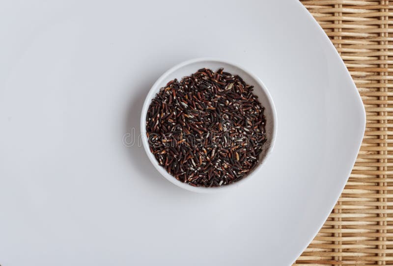 Background Photo of Dark Brown Rice on White Plate Stock Photo - Image ...