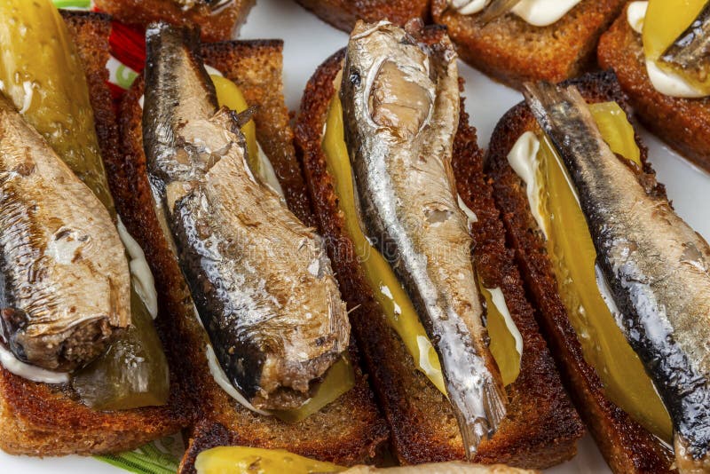 Background, Sprats with Pickles Lie on Toasted Bread. Close-up Stock ...