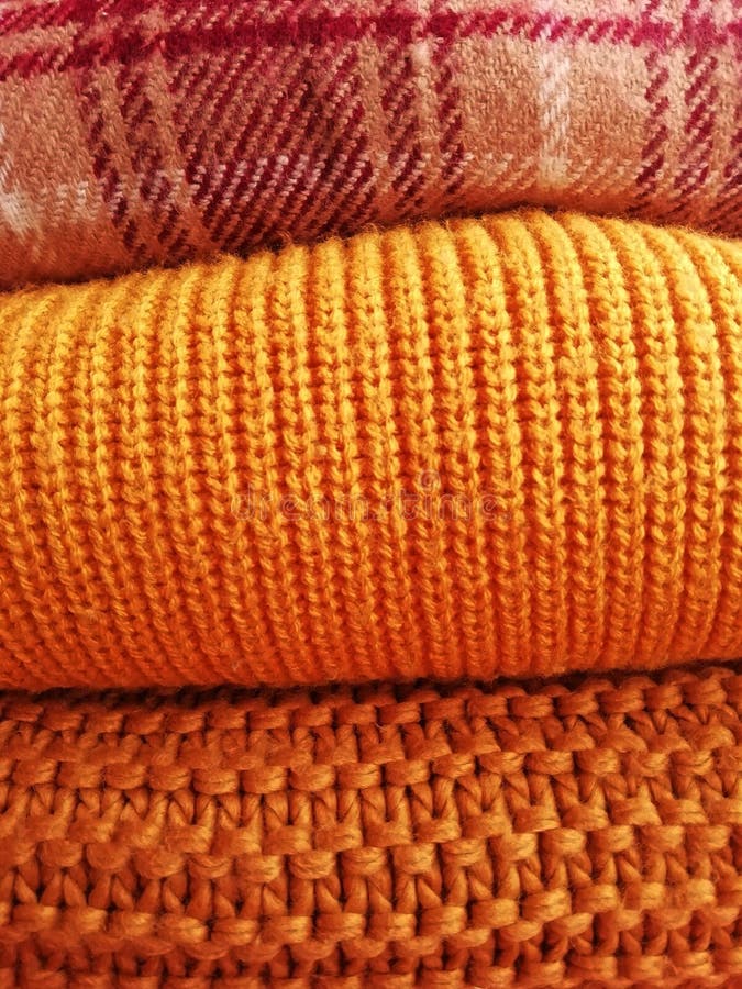 Background of a Stack of Knitted Pink and Orange Sweaters Stock Image ...