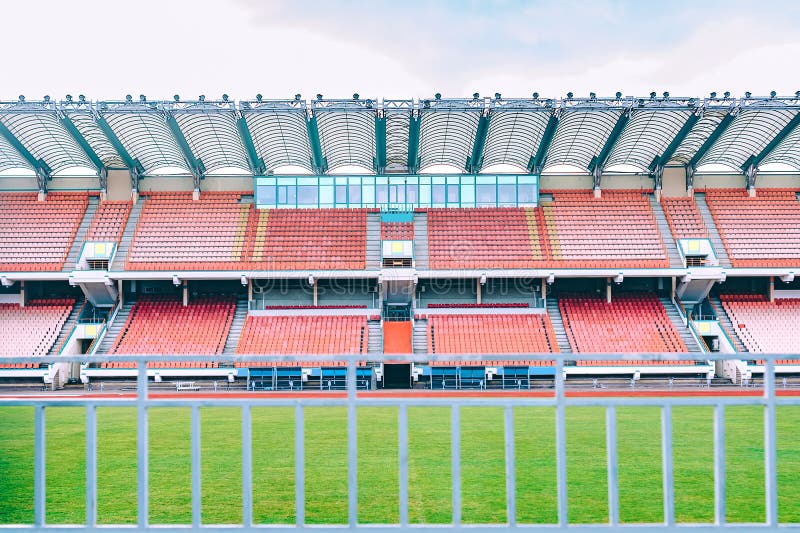 Background of the Stadium Tribune with Green Lawn Seats. Stock Photo ...